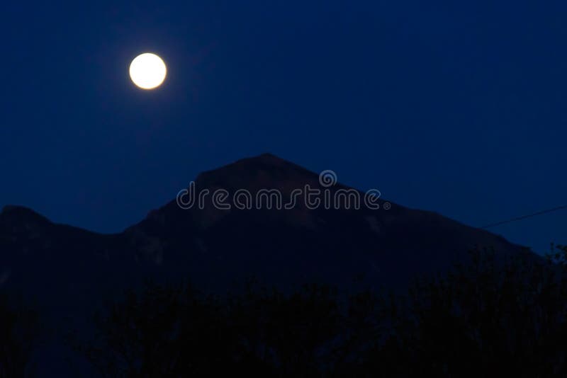 Full moon over a mountain stock image. Image of light - 167975473