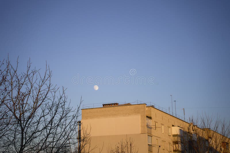 A Full Moon Over Paneled High-rise Building at Sunset Stock Image ...
