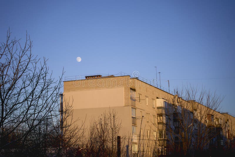 A Full Moon Over Paneled High-rise Building at Sunset Stock Photo ...