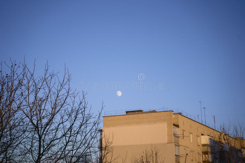 A Full Moon Over Paneled High-rise Building at Sunset Stock Image ...