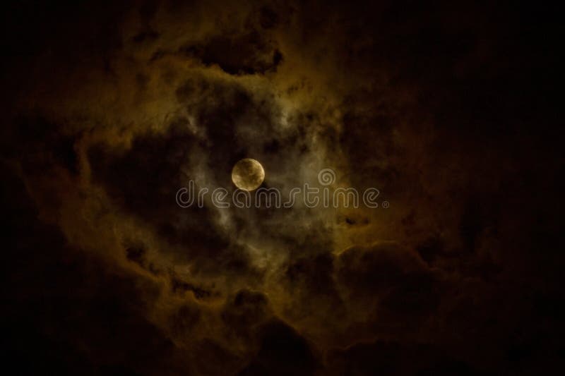 The Full Moon Peaking Out from Behind Storm Clouds. Stock Photo - Image ...