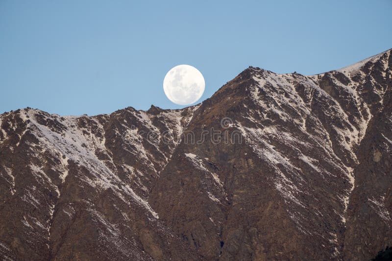 Full Moon Rise Over the Mountains on the Blue Sky Background Stock ...