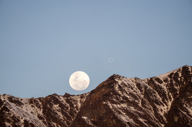 Full Moon Rise Over the Mountains on the Blue Sky Background Stock ...