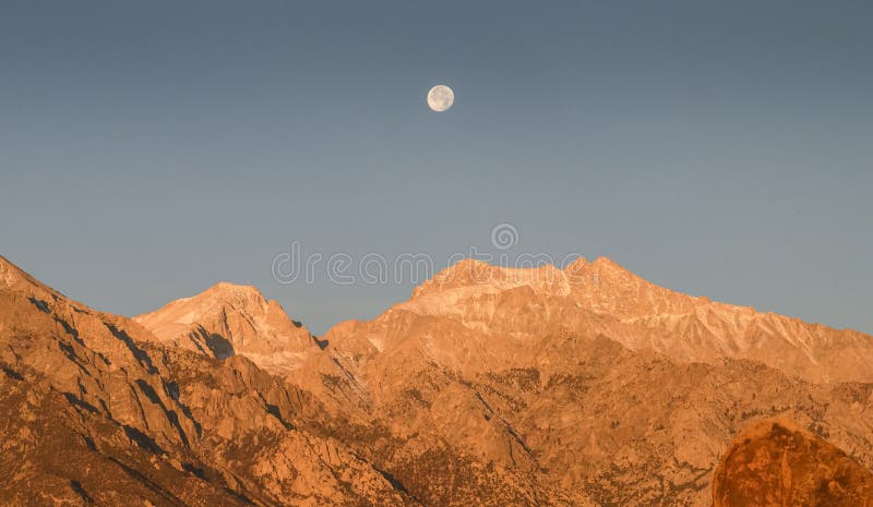 Full Moon Rise Over Peaks stock photo. Image of sunrise - 254497874