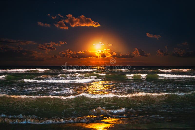 Full Moon Rising Over Sea Waves. Dramatic Sunset Over Beach Stock Photo ...