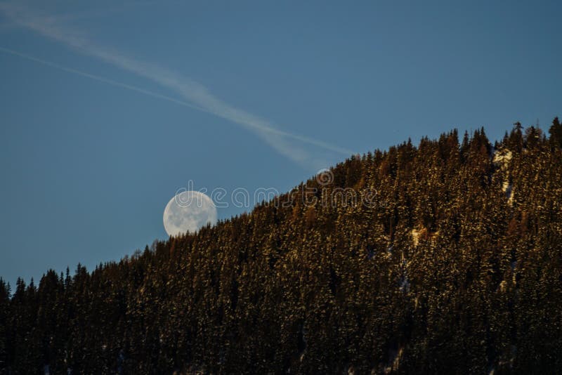 The Full Moon Setting Behind the Mountain Stock Photo - Image of ...