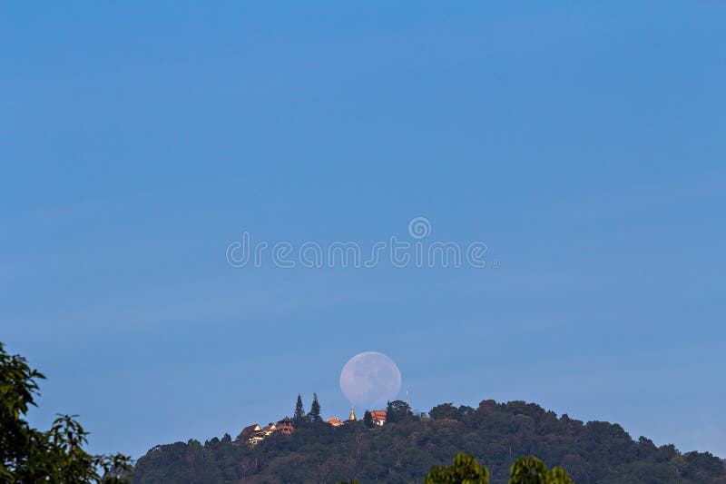 Full Moon Setting Over Buddhist Temple on Mountain Stock Photo - Image ...