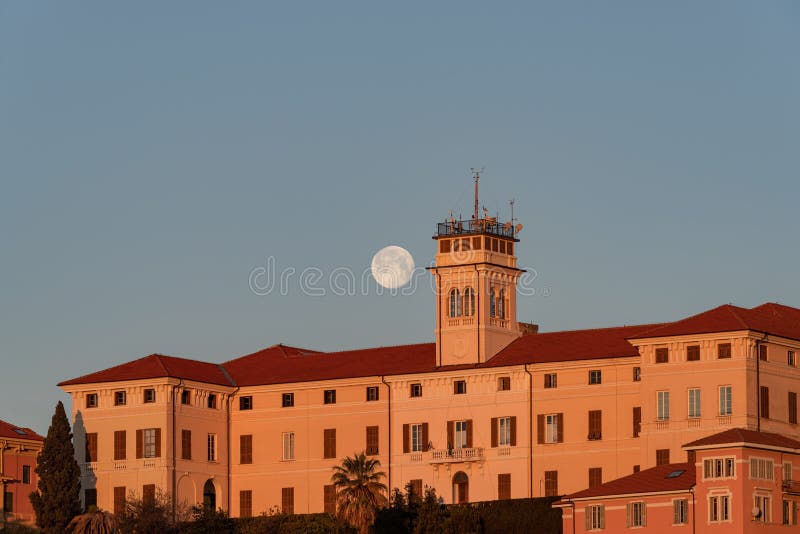 Full Moon Setting at Sunrise Stock Image - Image of moonset, building ...