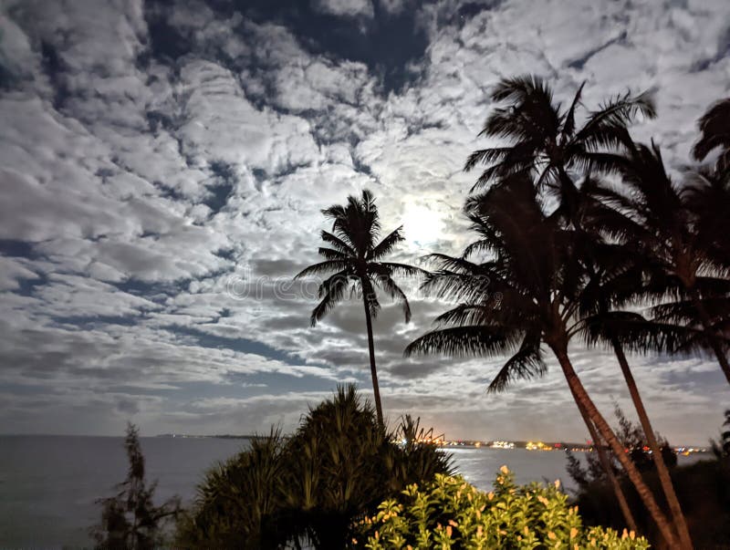 Full Moon Shines through the Clouds Over Hilo Bay Stock Photo - Image ...