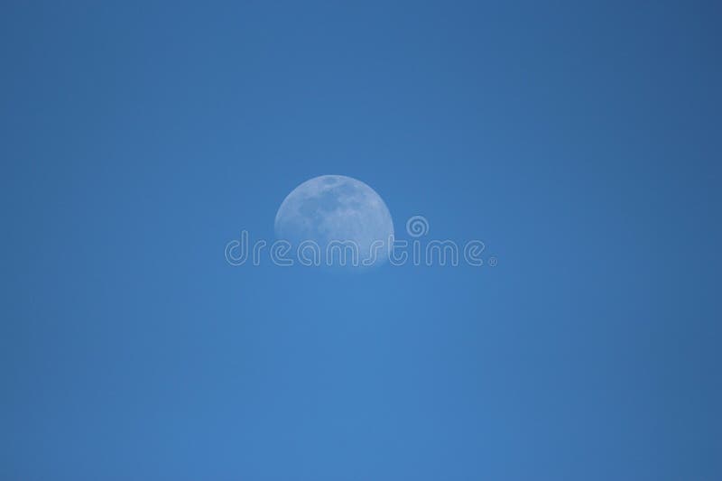 A Full Moon Visible Against a Clear Blue Sky during the Daytime Stock ...