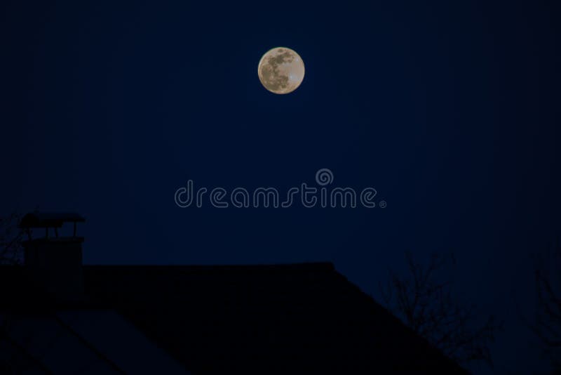 Full Moonrise in spring stock photo. Image of houses - 142575136