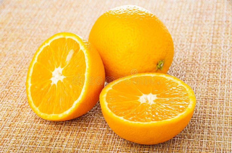 Full Orange and Halves of Orange on Brown Mat Stock Image - Image of ...