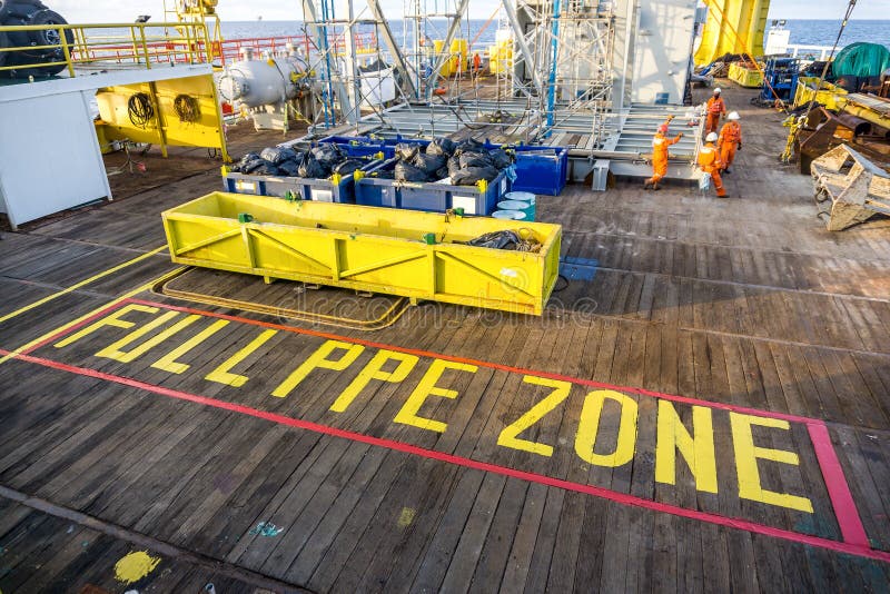 A Team of Rigger Lifting an Anchor from a Construction Work Barge Stock ...