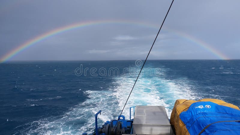 Full rainbow at sea 2 stock photo. Image of rainbow - 140033926