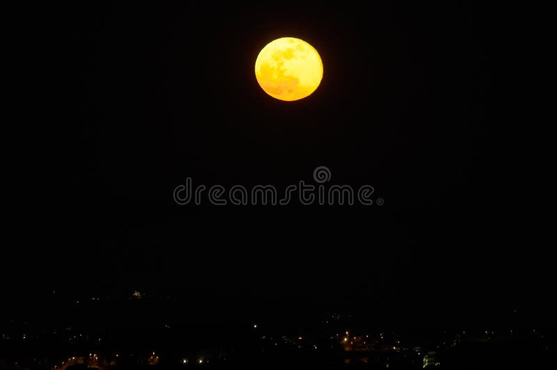 Full Red Moon in the Dark Sky and City Lights on the Bottom Stock Image ...