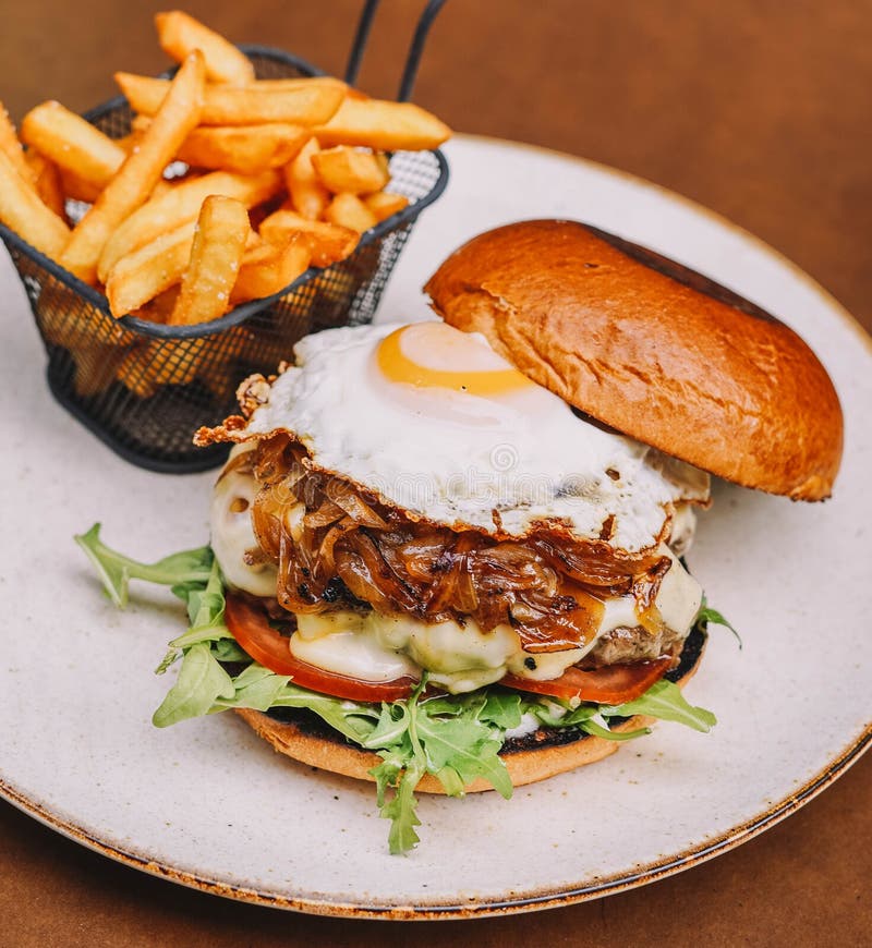Full Rustic Beef Burger with Fries and Fried Egg Stock Photo - Image of ...