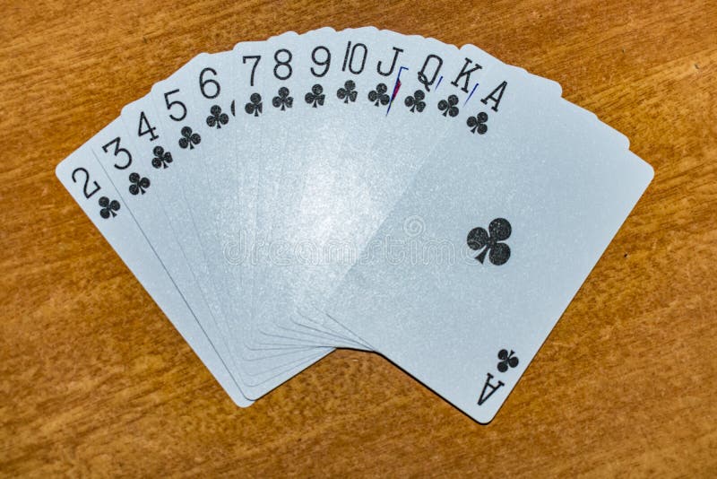 A Full Set of Clubs in Playing Card Laying on the Table with an ...