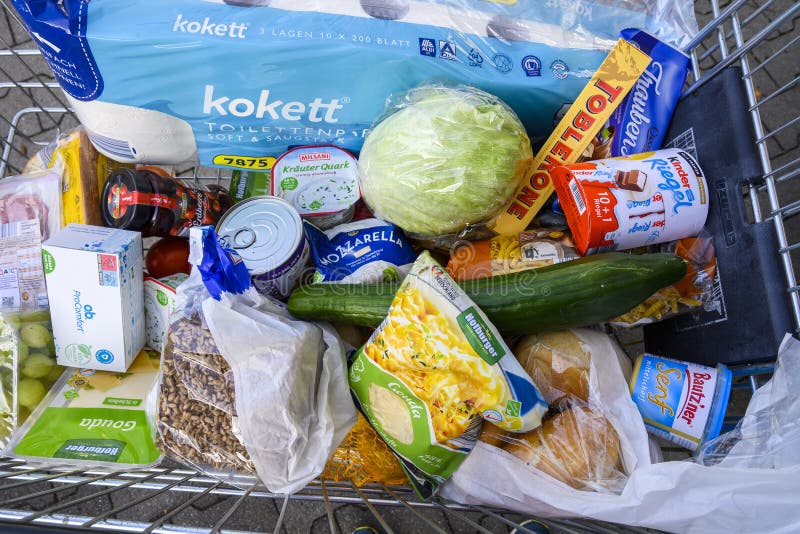 A Full Shopping Cart with Various Products for daily Needs Editorial ...
