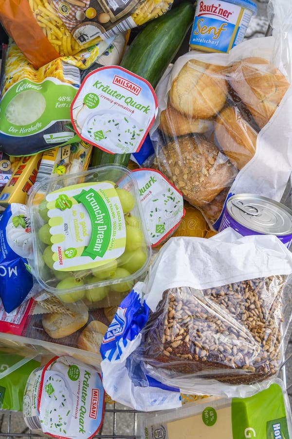 A Full Shopping Cart with Various Products for daily Needs Editorial ...