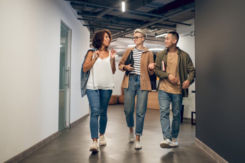 Group of Company Employees Discussing Business Matters in the Hallway ...