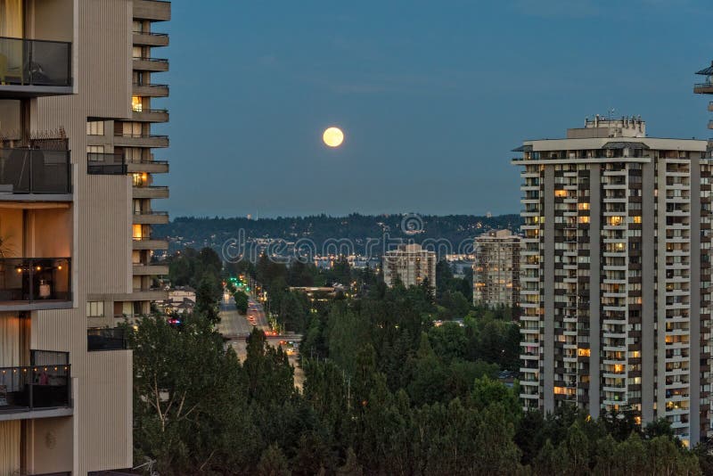 Full Yellow Moon Raising Over Night City Stock Image - Image of mistery ...