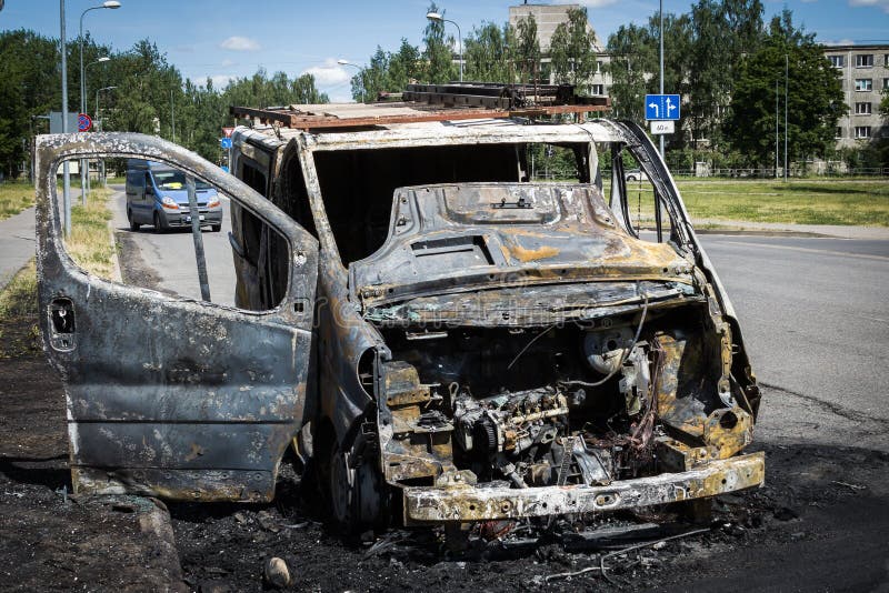 Fully burned car on a road stock image. Image of damaged - 117979215