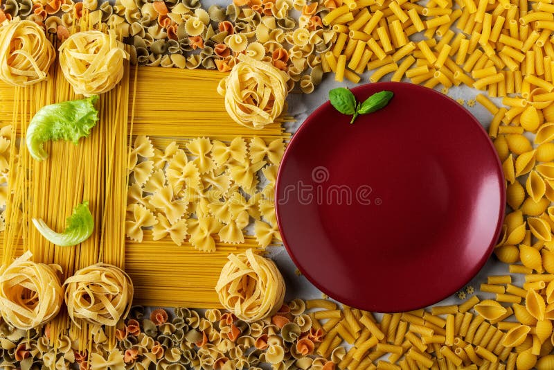 A Fully Filled Pasta Frame with a Red Ceramic Plate and Basil and ...