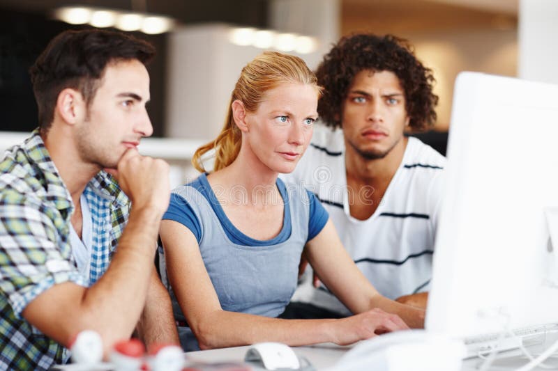 Fully Focused on Their Team Project. a Group of Colleagues Working in ...