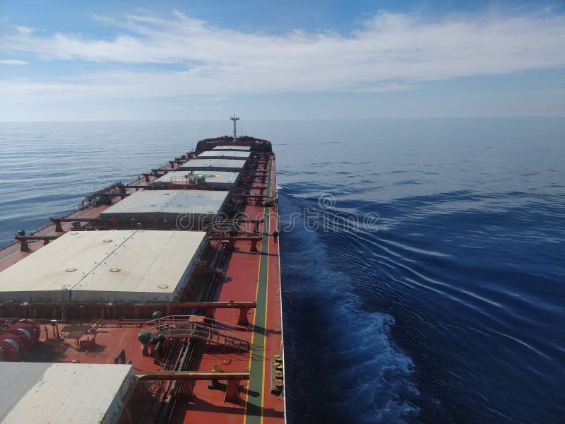 A Fully Loaded Bulk Carrier Ship Running Onto the Sunset Stock Image ...