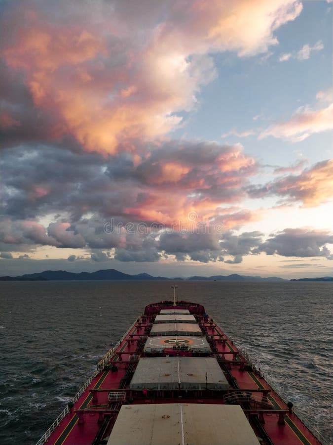 A Fully Loaded Bulk Carrier Ship Running Onto the Sunset Stock Image ...