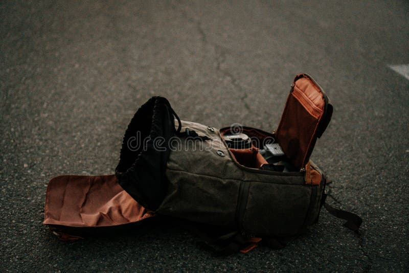 Fully Open Gray Canvas Camera Utility Backpack Laid on the Ground with ...