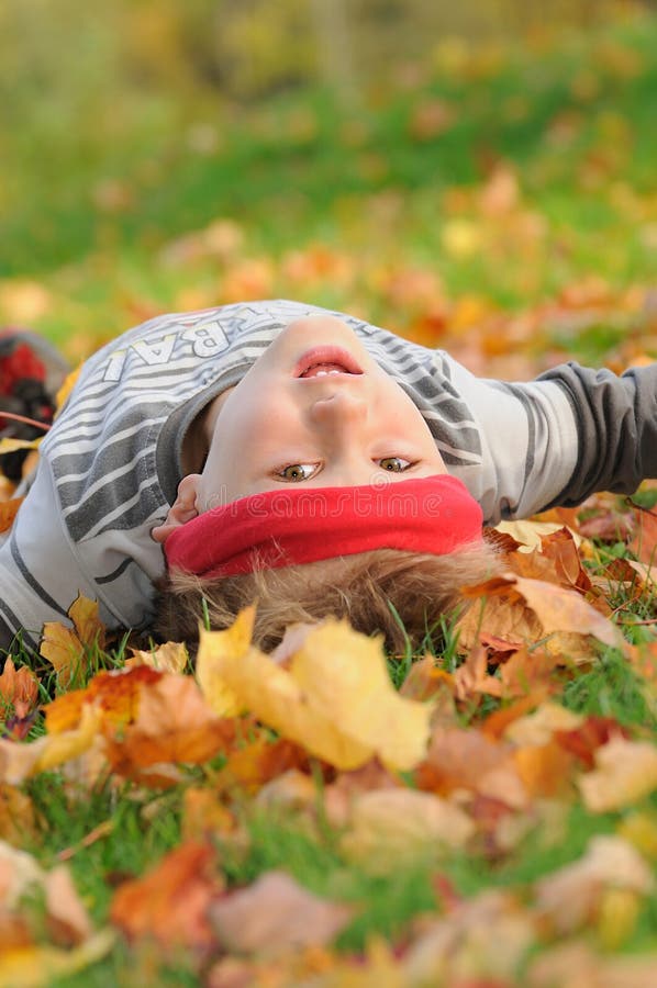 Kids buried in fall leaves stock photo. Image of youth - 7583364