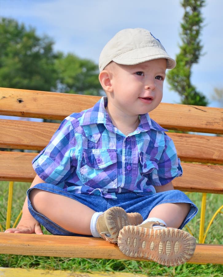 Fun baby sitting on bench stock photo. Image of small - 28308838