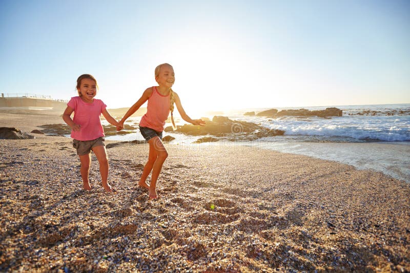 Fun on the Beach. Two Little Girls Having Fun on the Beach. Stock Photo ...