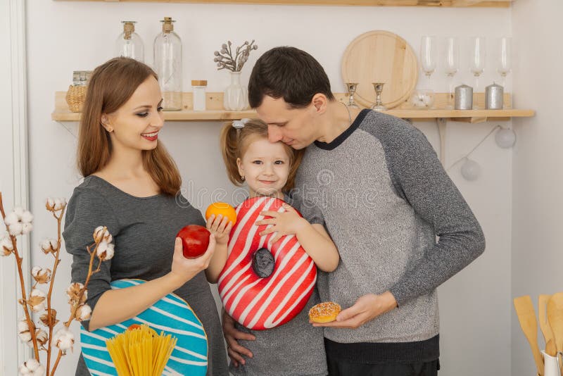 Fun and Beautiful Family of Three Having Fun in the Kitchen. Stock ...