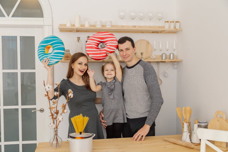 Fun and Beautiful Family of Three Having Fun in the Kitchen. Stock ...