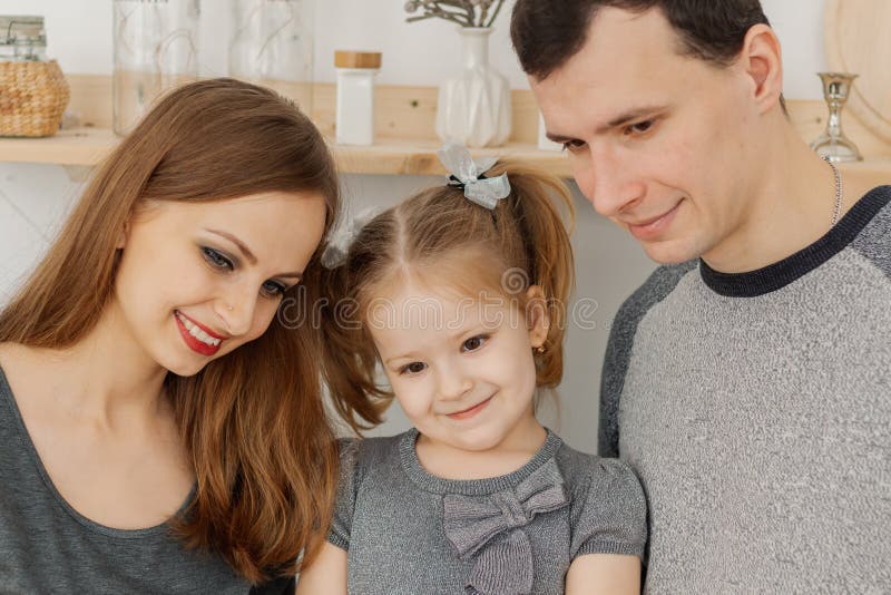 Fun and Beautiful Family of Three Having Fun in the Kitchen. Stock ...