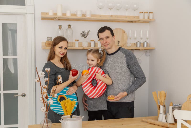 Fun and Beautiful Family of Three Having Fun in the Kitchen. Stock ...