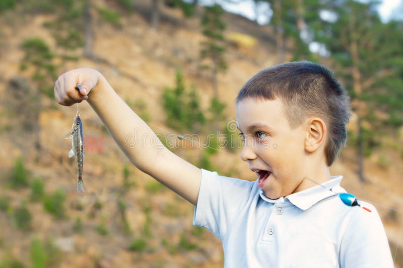 Fun boy with small fish stock image. Image of person - 31822739