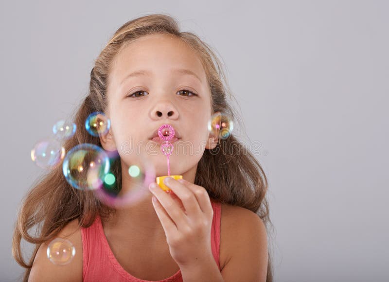 Fun with Bubbles. Studio Shot of a Cute Little Girl Blowing Bubbles ...