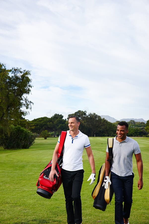 Fun and Exercise. Two Men Walking Across a Golf Course with Their Golf ...