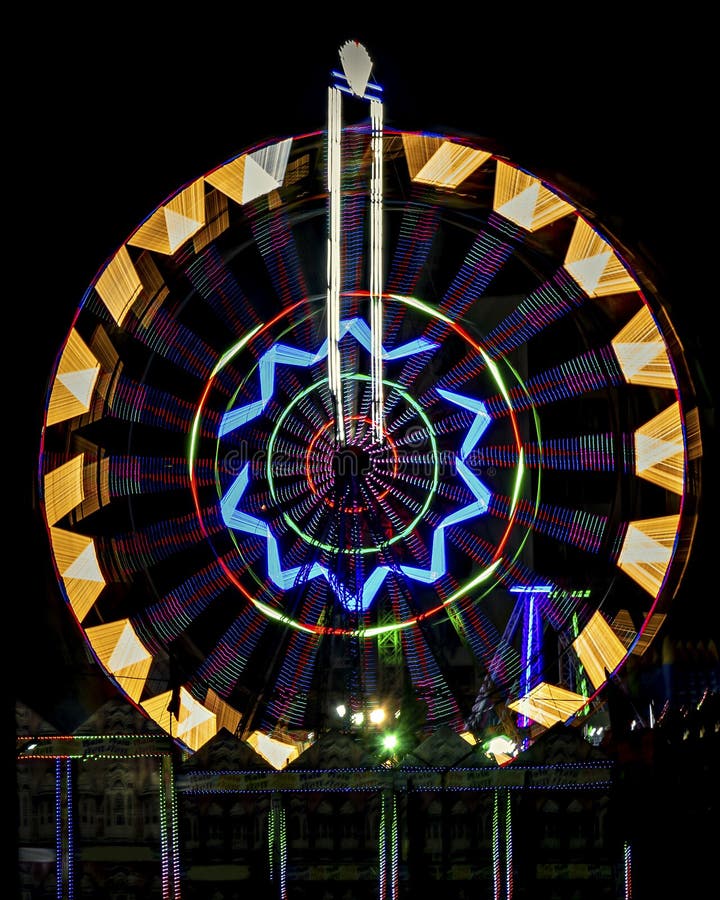 Fun Fair Giant Colorful Ferris Wheel Spinning at Night. Slow Shutter ...