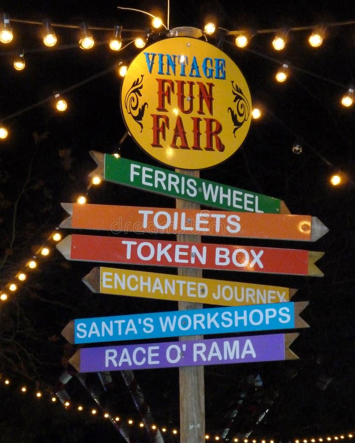 Fun Fair Sign Post at Night with Twinkly Lights Stock Photo - Image of ...