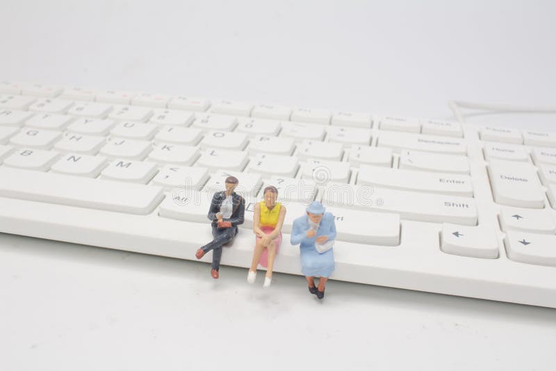 A Fun of Figure Sit on the Key Board Stock Photo - Image of technology ...