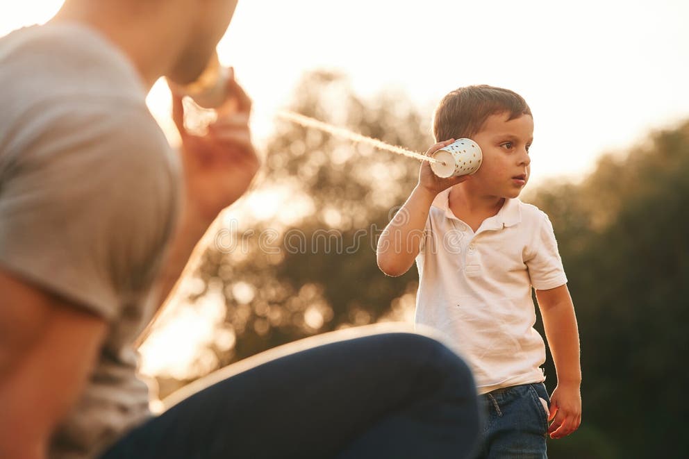 Fun, Holding and Using String Can Phone. Father and Little Son are ...