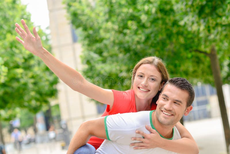 Fun loving couple outdoors stock photo. Image of green - 260650512