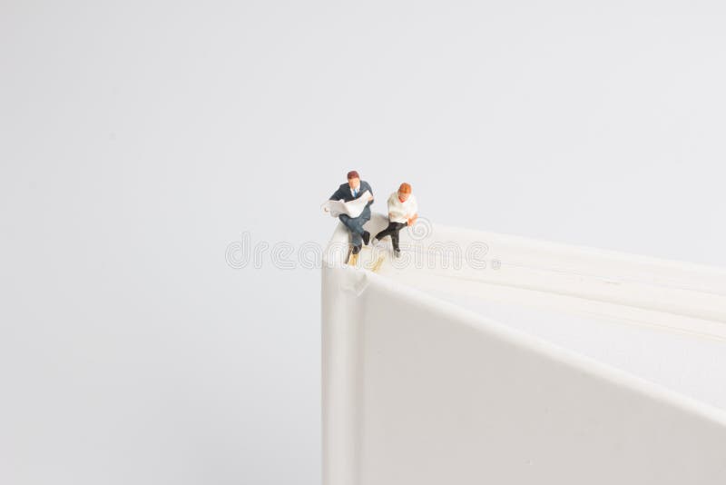The Fun of Mini Figure Reading on Book Stock Image - Image of figure ...