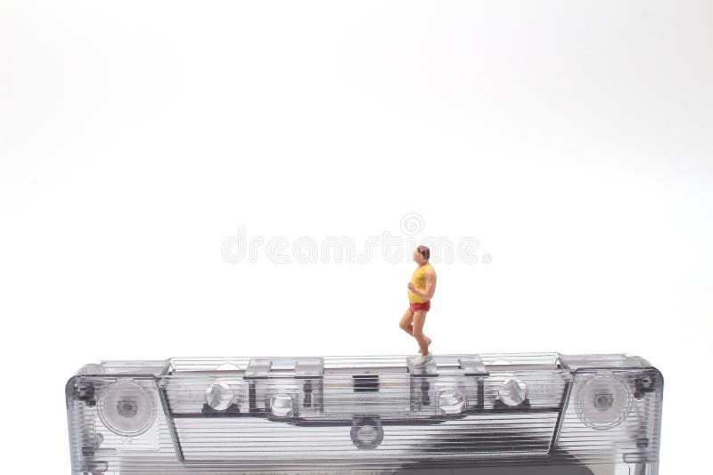 A Fun Mini Figure Running on a Music Cassette Stock Image - Image of ...