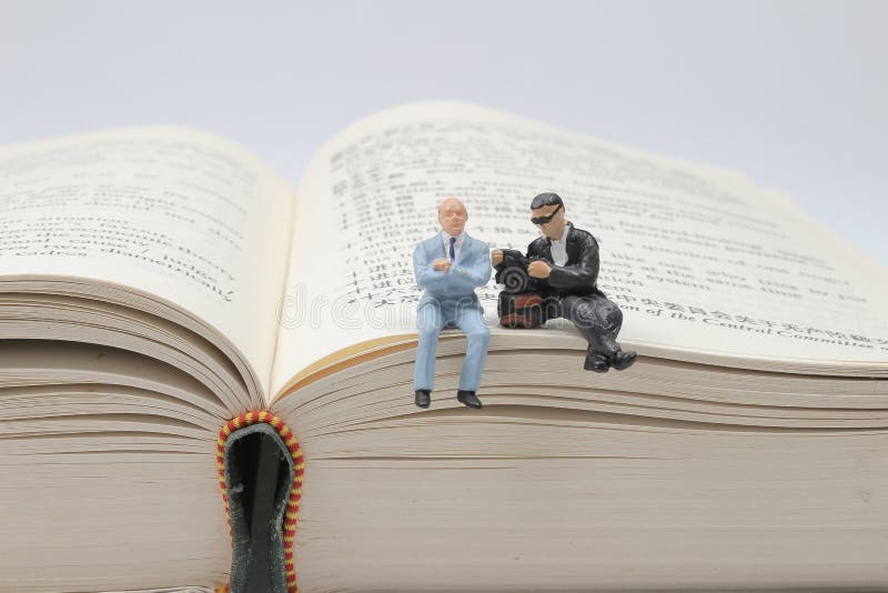 A Fun of Mini People:figure Sitting on Book Stock Image - Image of note ...