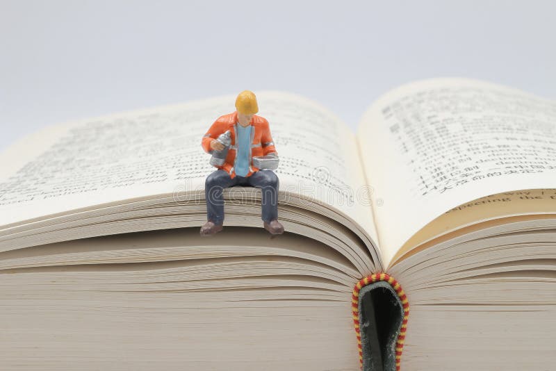 A Fun of Mini People:figure Sitting on Book Stock Photo - Image of ...